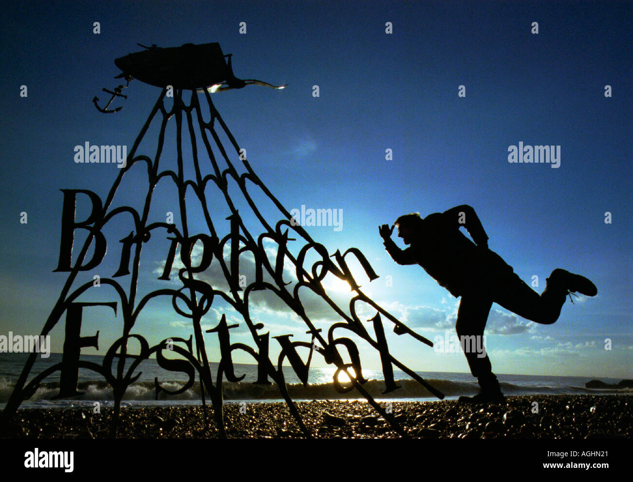 Proud artist leaps about in front of his sculpture inspired by the ...