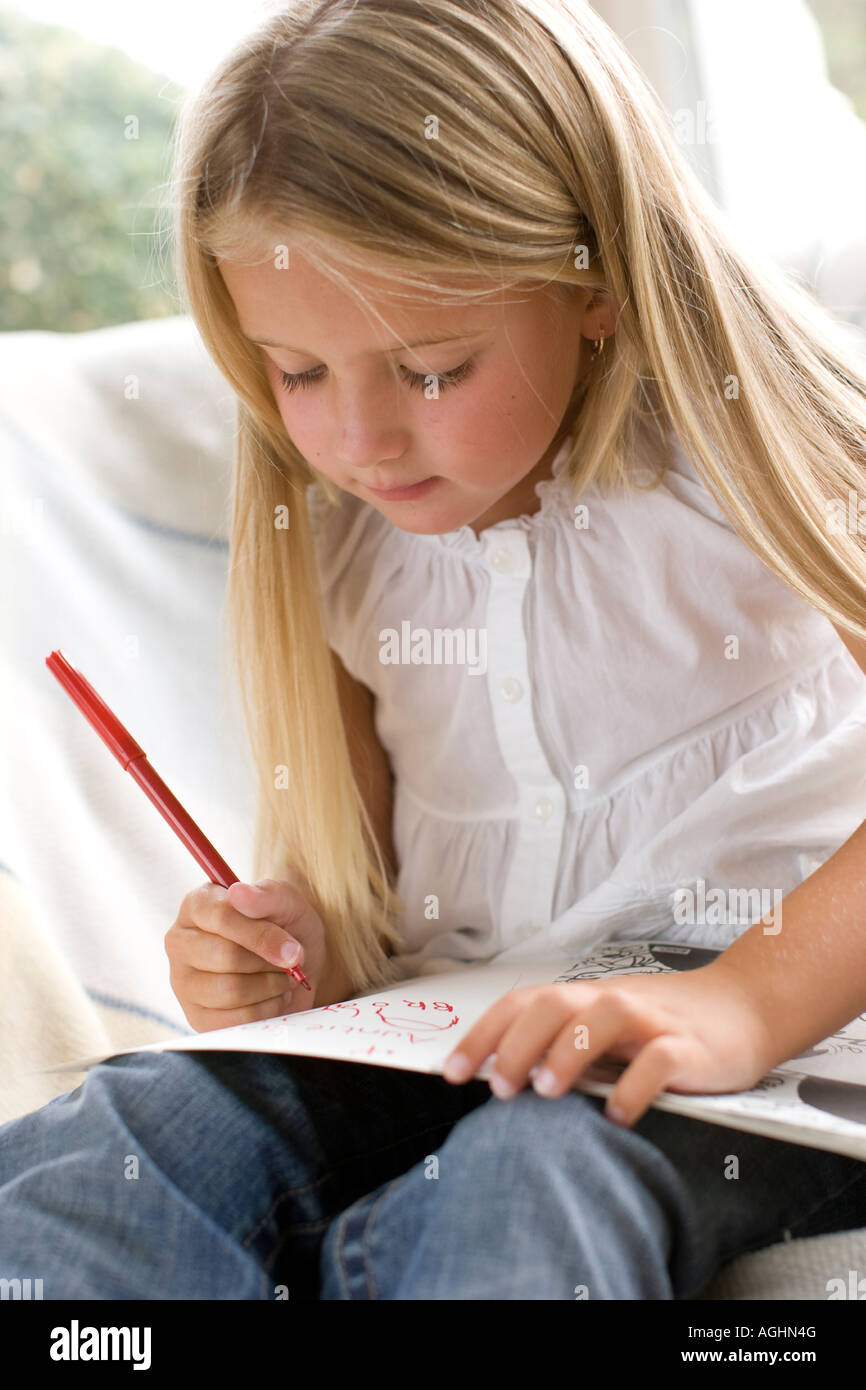 child writing an activity book Stock Photo - Alamy
