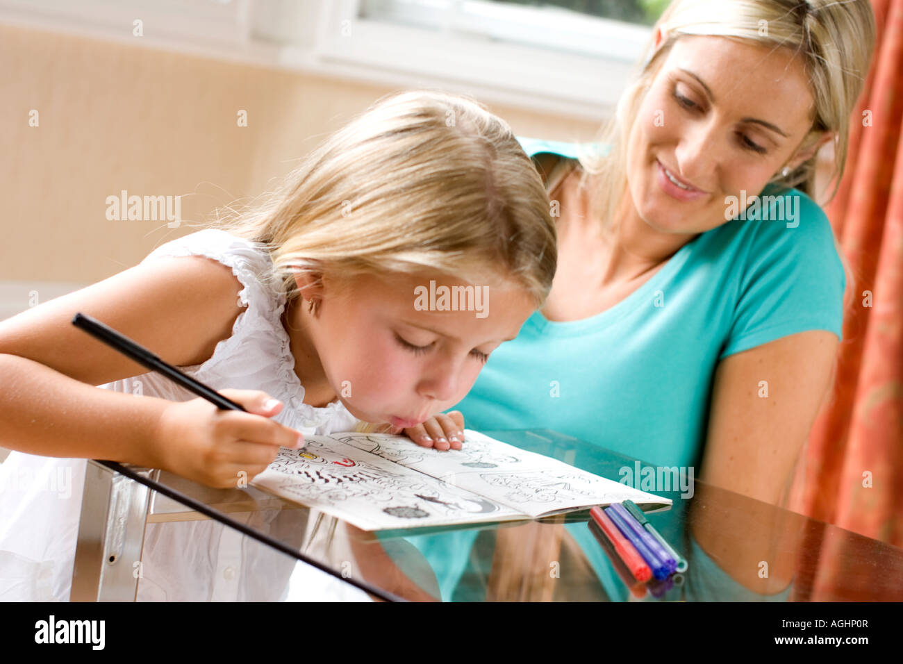 child using an activity book Stock Photo - Alamy