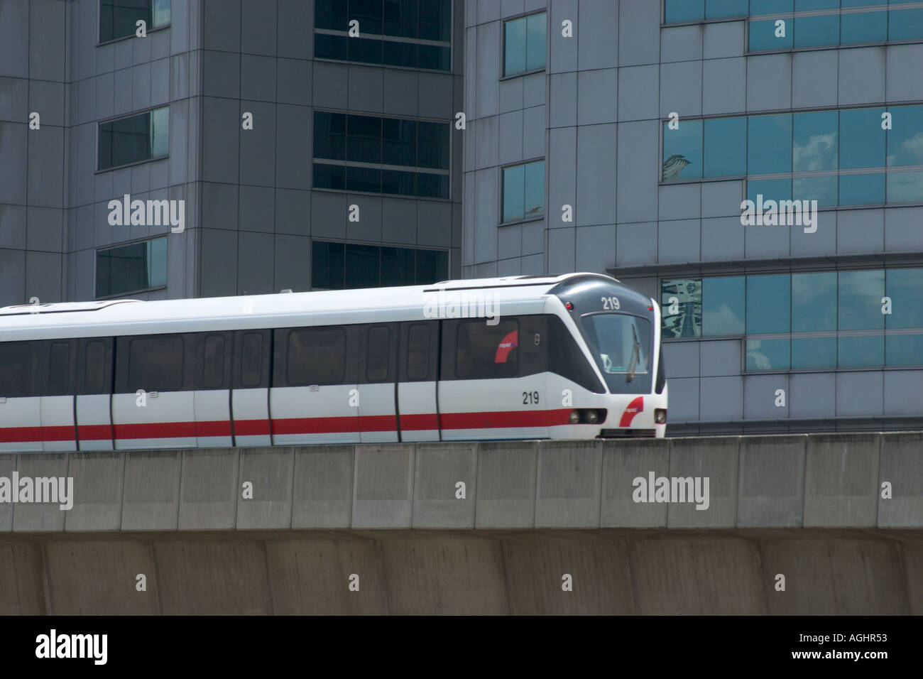 LRT train moving in front of building in Malaysia Stock Photo - Alamy