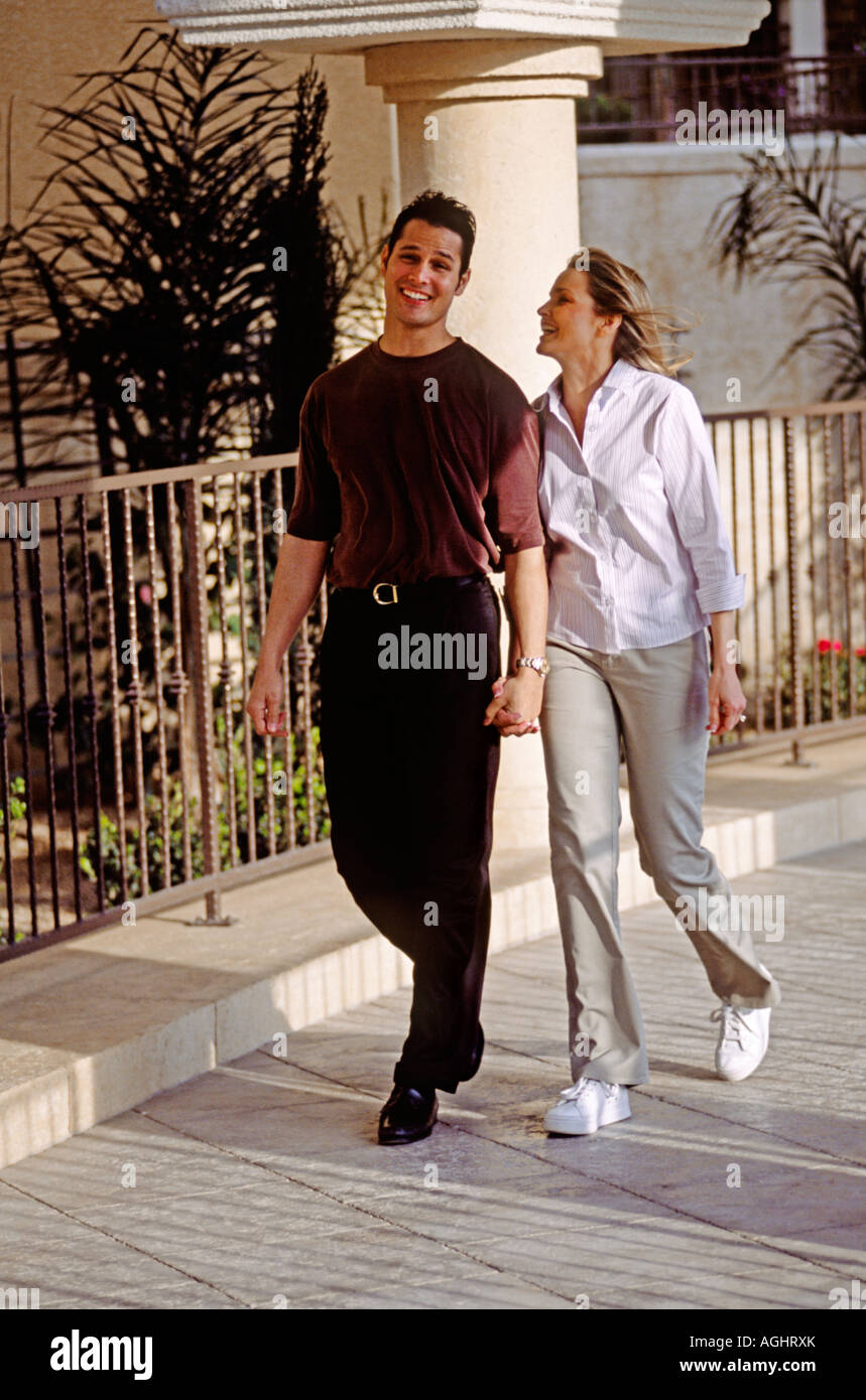 ROMANTIC COUPLE walk along a pathway Stock Photo - Alamy