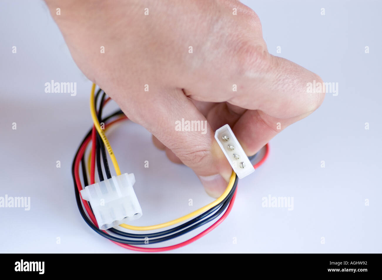 Hand holding an internal PC power cable showing clear view of connector ...