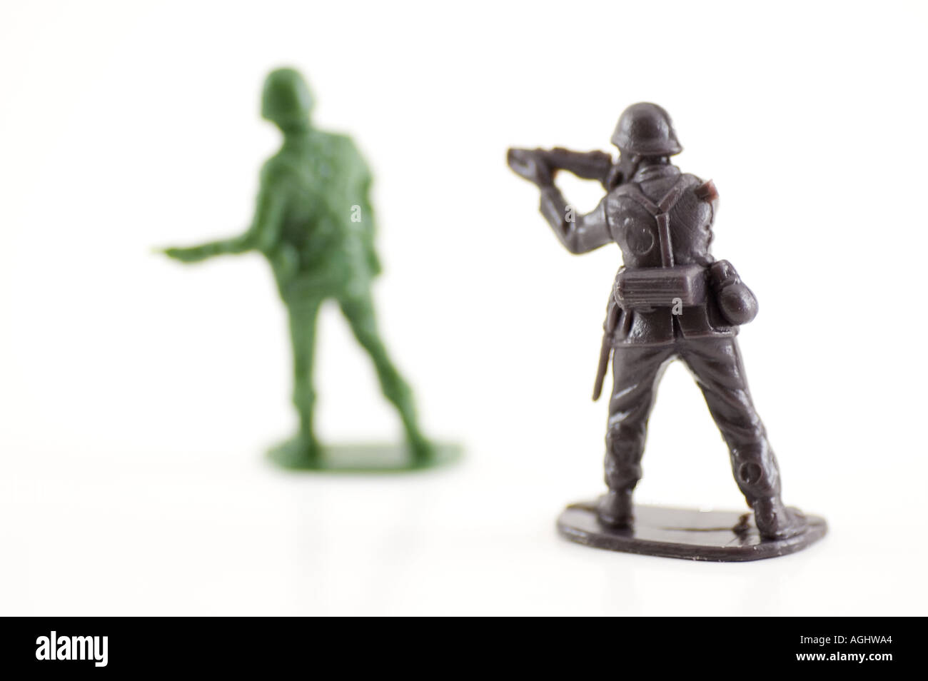 Plastic toy soldiers at war The enemy sneaks up on one unsuspecting ...