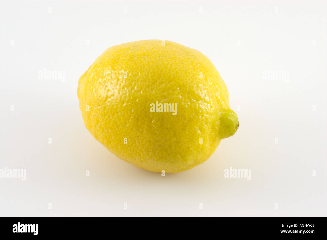 Single whole lemon against a white background Stock Photo - Alamy