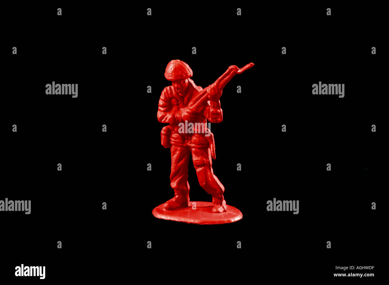 One blood red plastic toy soldier against a black background Stock ...