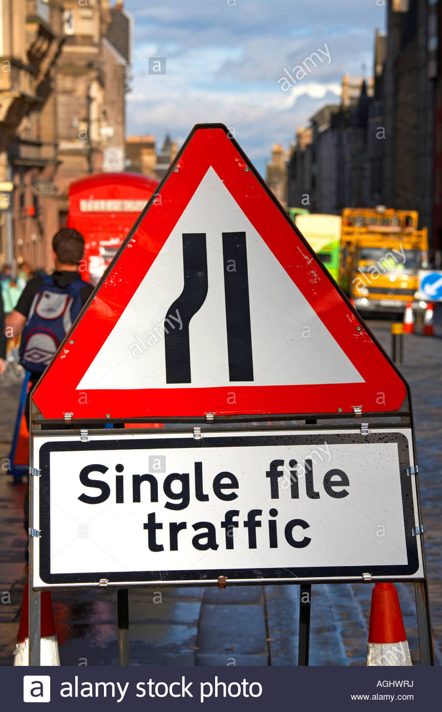 Single file traffic signpost Stock Photo - Alamy