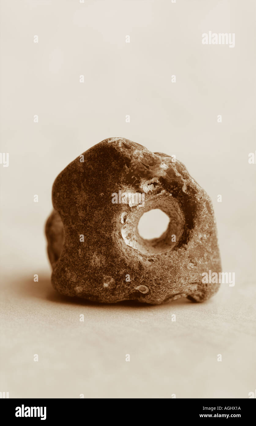 flint stone with hole shot in studio Stock Photo - Alamy