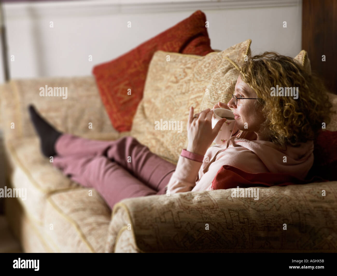 young woman putting her feet up Stock Photo - Alamy