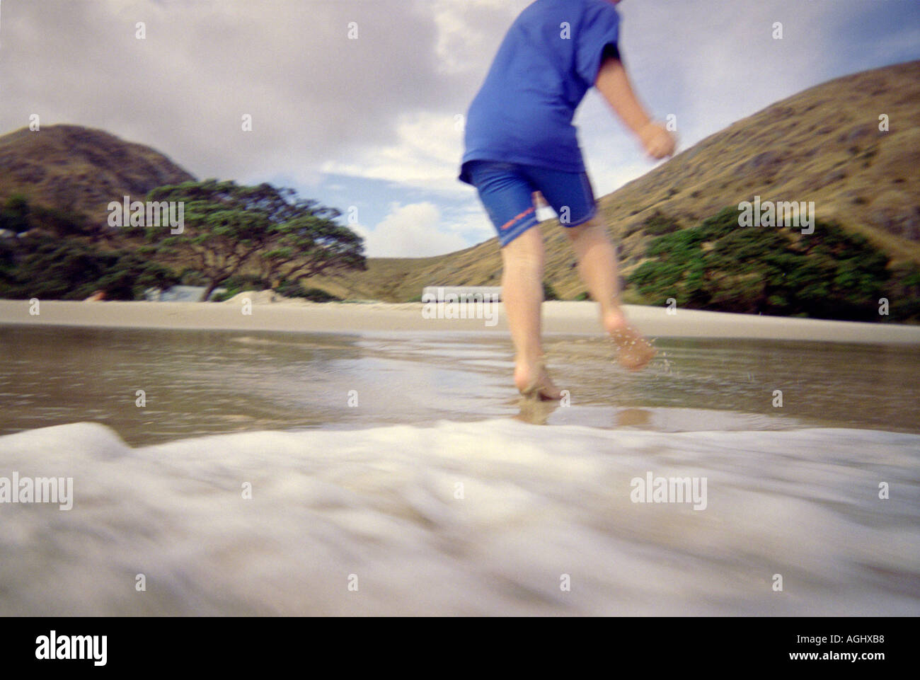 Child watching the waves at sunset hi-res stock photography and images ...