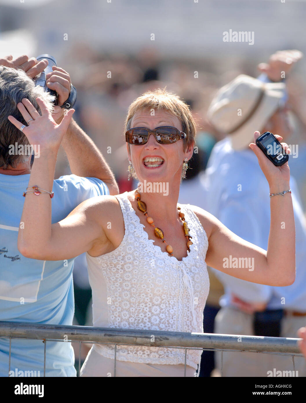 A spectator in crowd waves and smiles. Picture by Jim Holden Stock ...