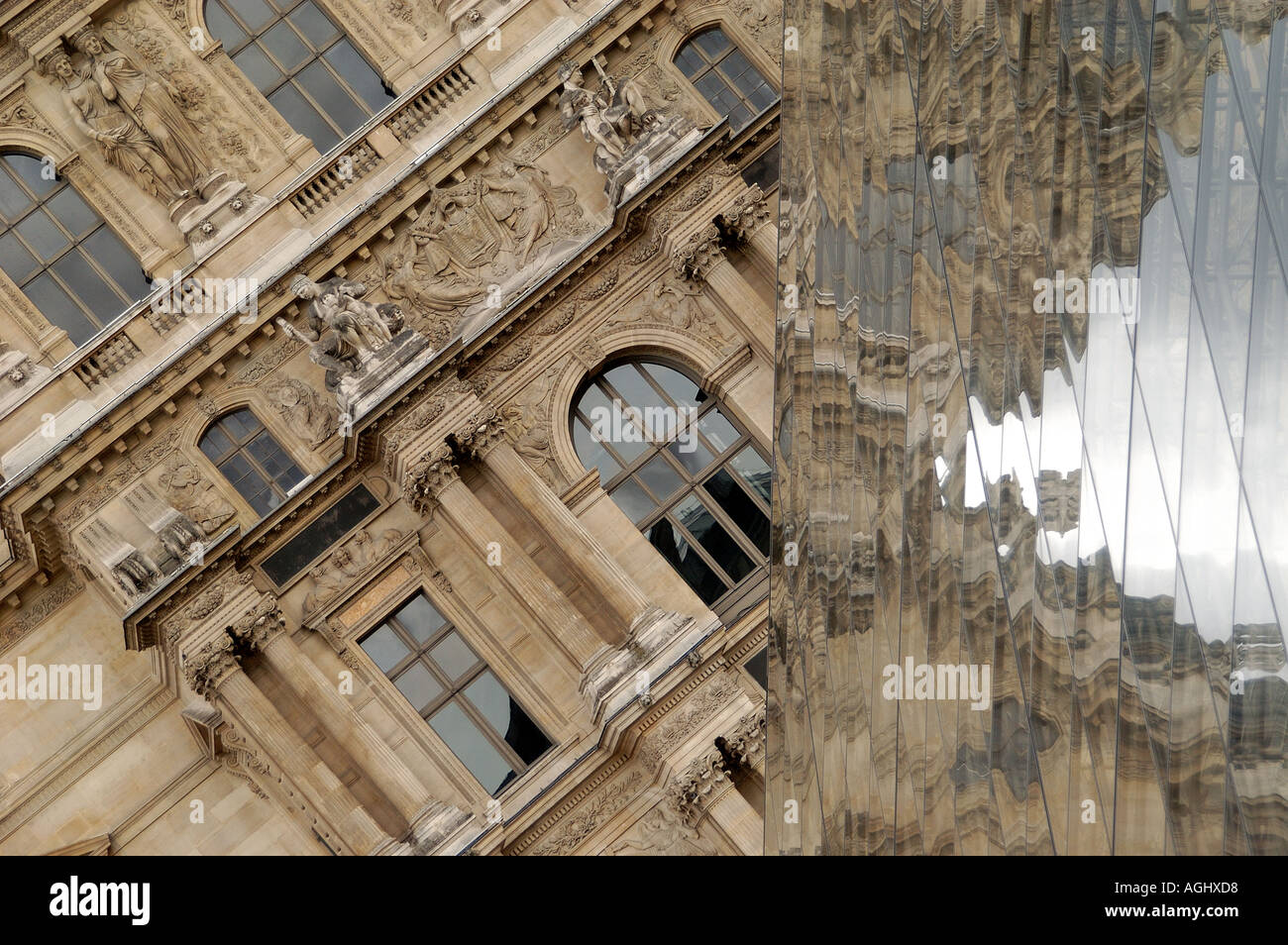 Modern glass pyramid and French Renaissance facade of the Louvre Museum ...