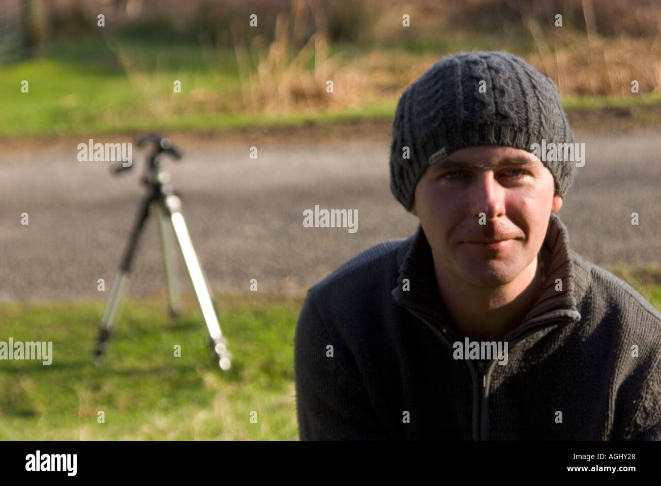 portrait of man with tripod in background Stock Photo - Alamy