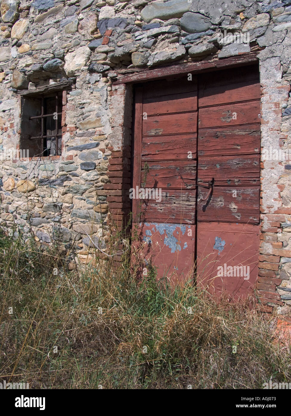 Stone barn with weathered red wooden doors Tuscany Italy Stock Photo ...