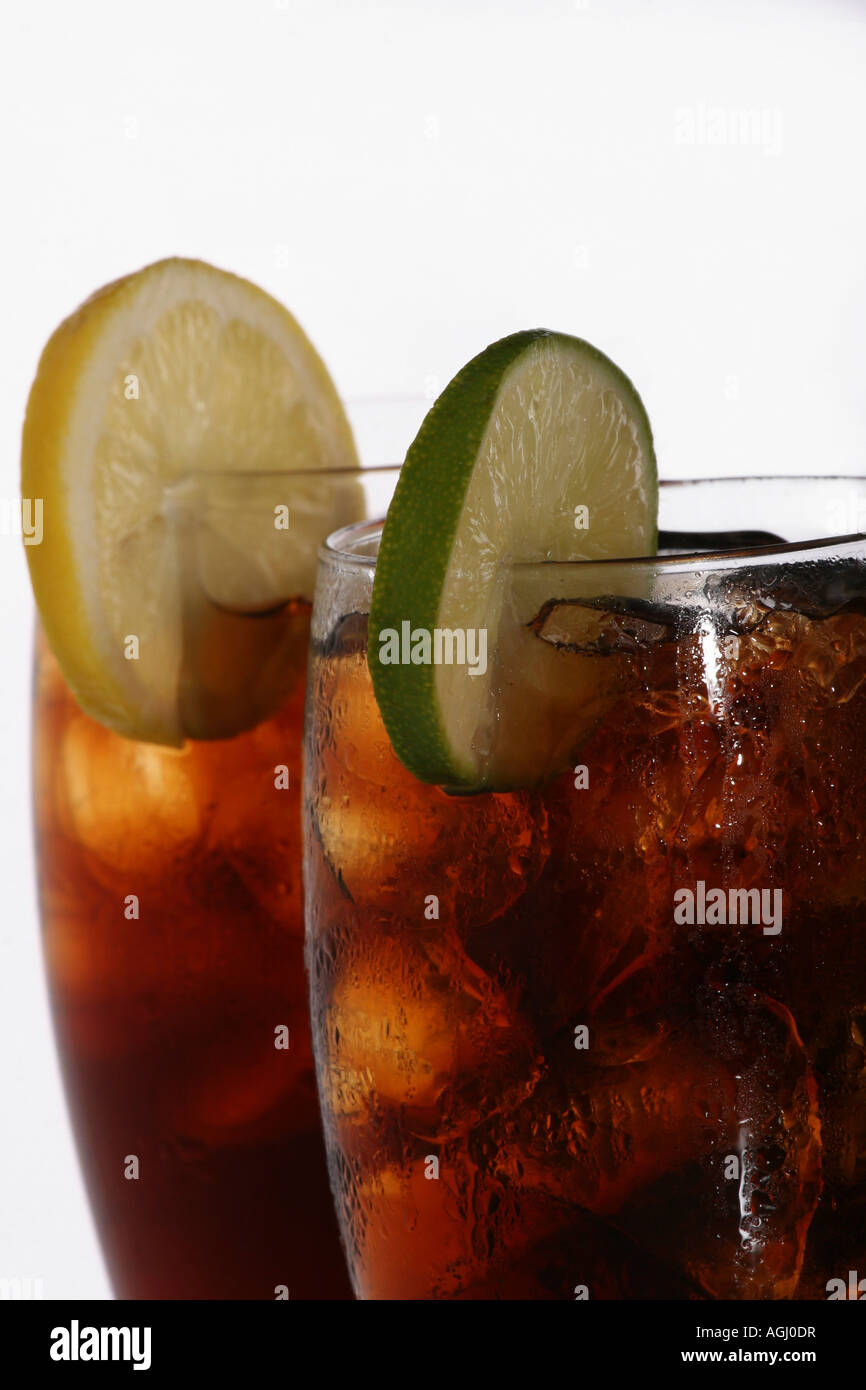 A glass of Coca Cola with ice cubes and a slice of green Lime Coke soft ...
