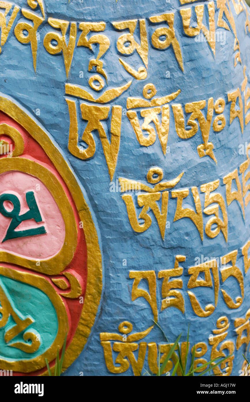 Stone painted with tibetan wheel and mantra text writing. Swayambhu ...