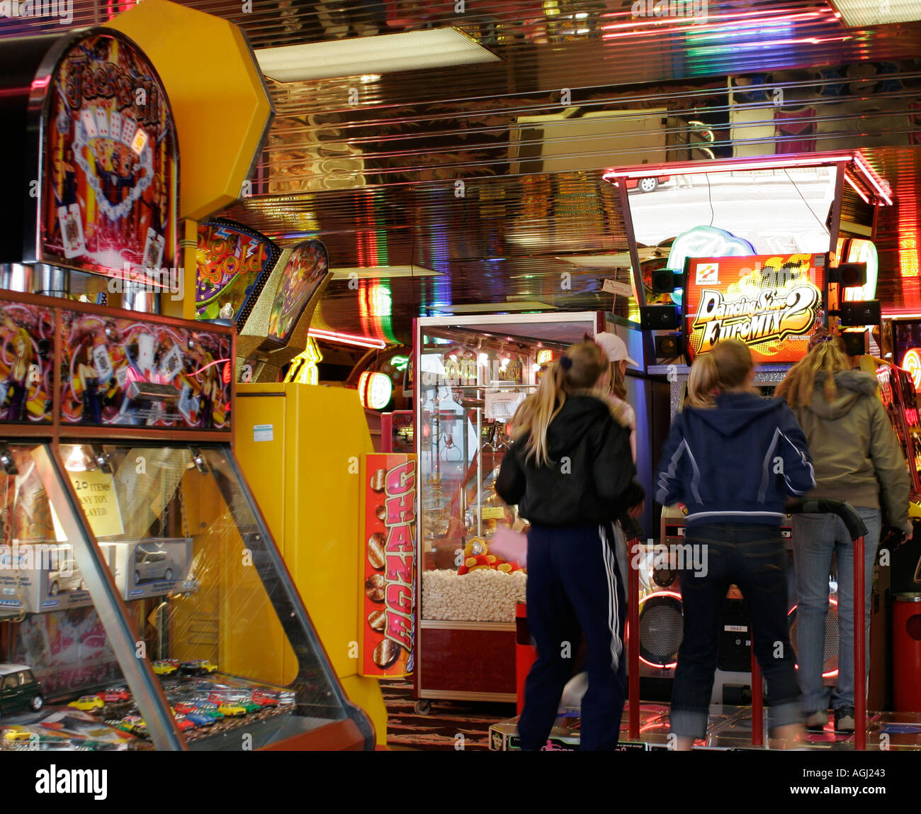 Teenage girls with dancing machine in amusement arcade Hastings UK ...