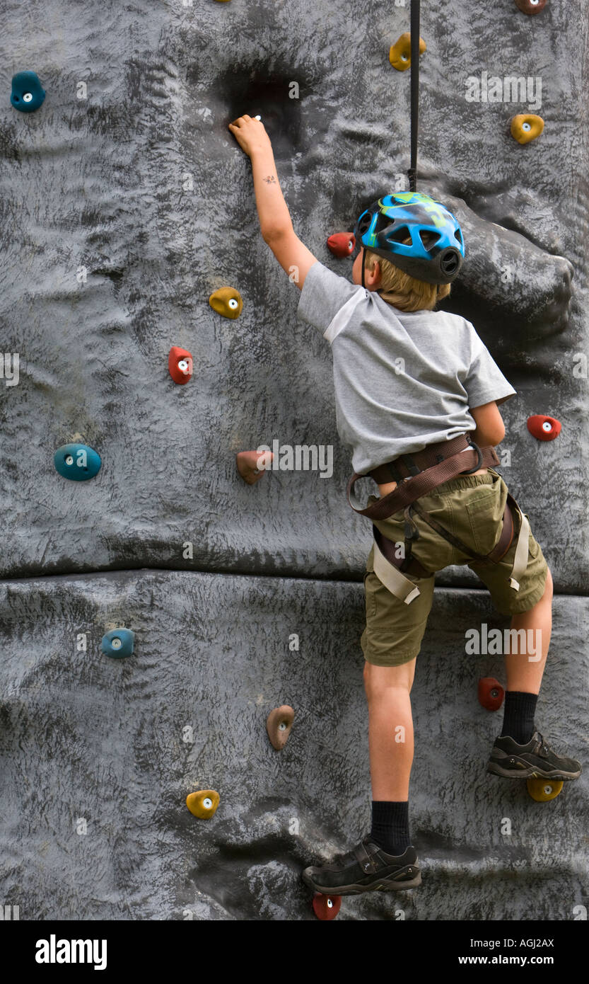 A young boy climbing an artificial rock wall Stock Photo - Alamy