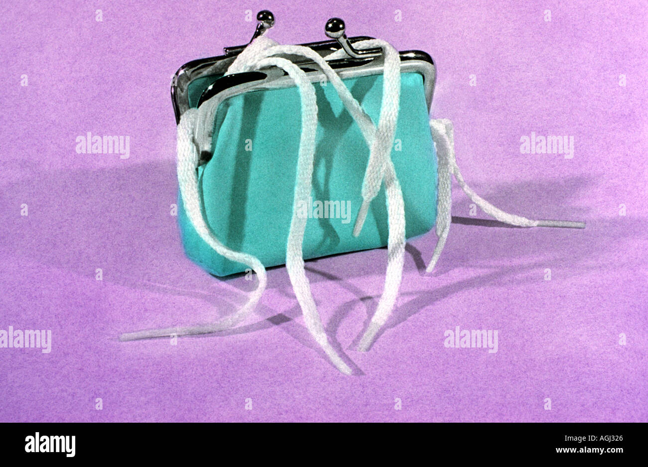 Shoestrings hanging out of change purse Stock Photo - Alamy