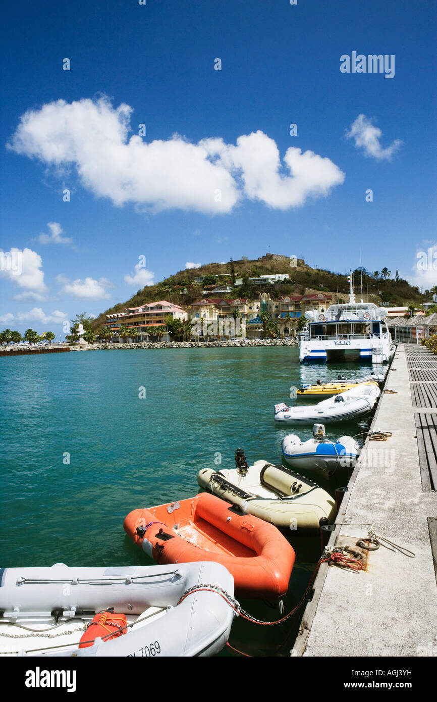 Inflatable rafts with a boat docked at a harbor Stock Photo - Alamy