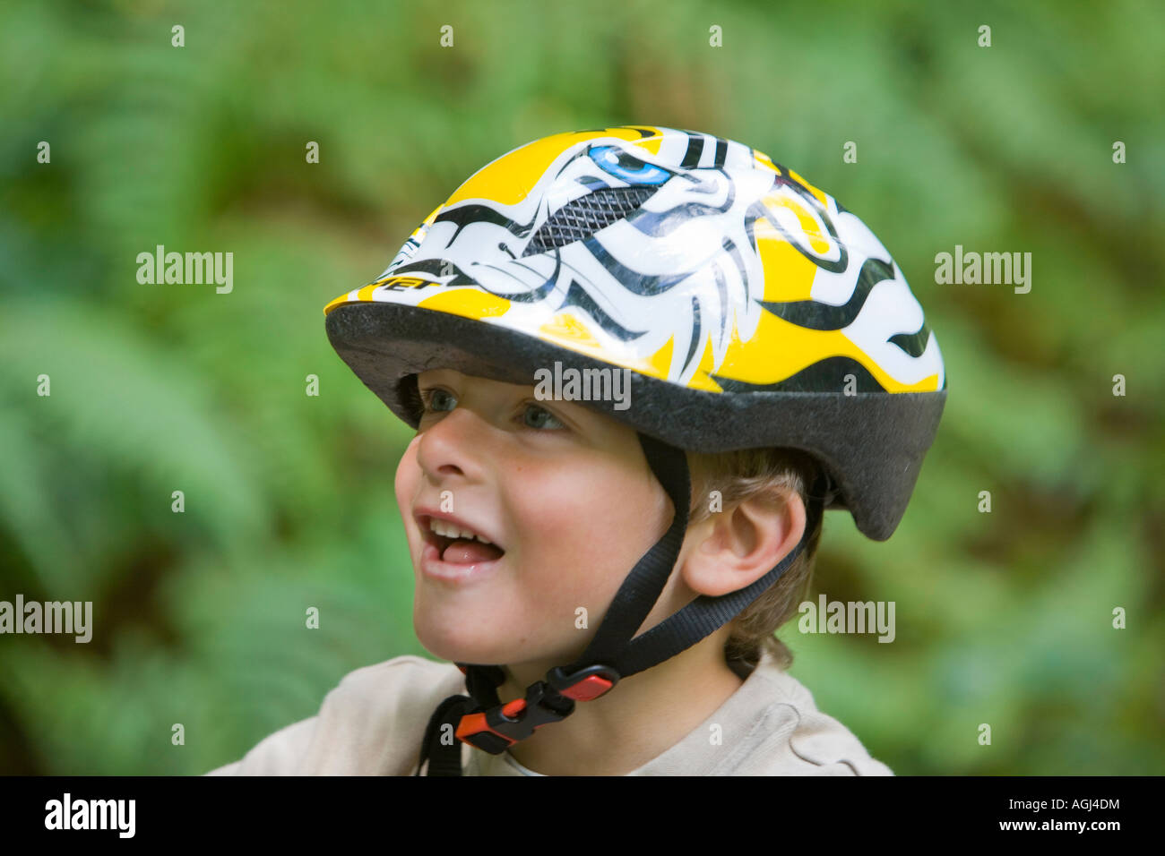 A young boy wearing a cycling helmet Stock Photo - Alamy