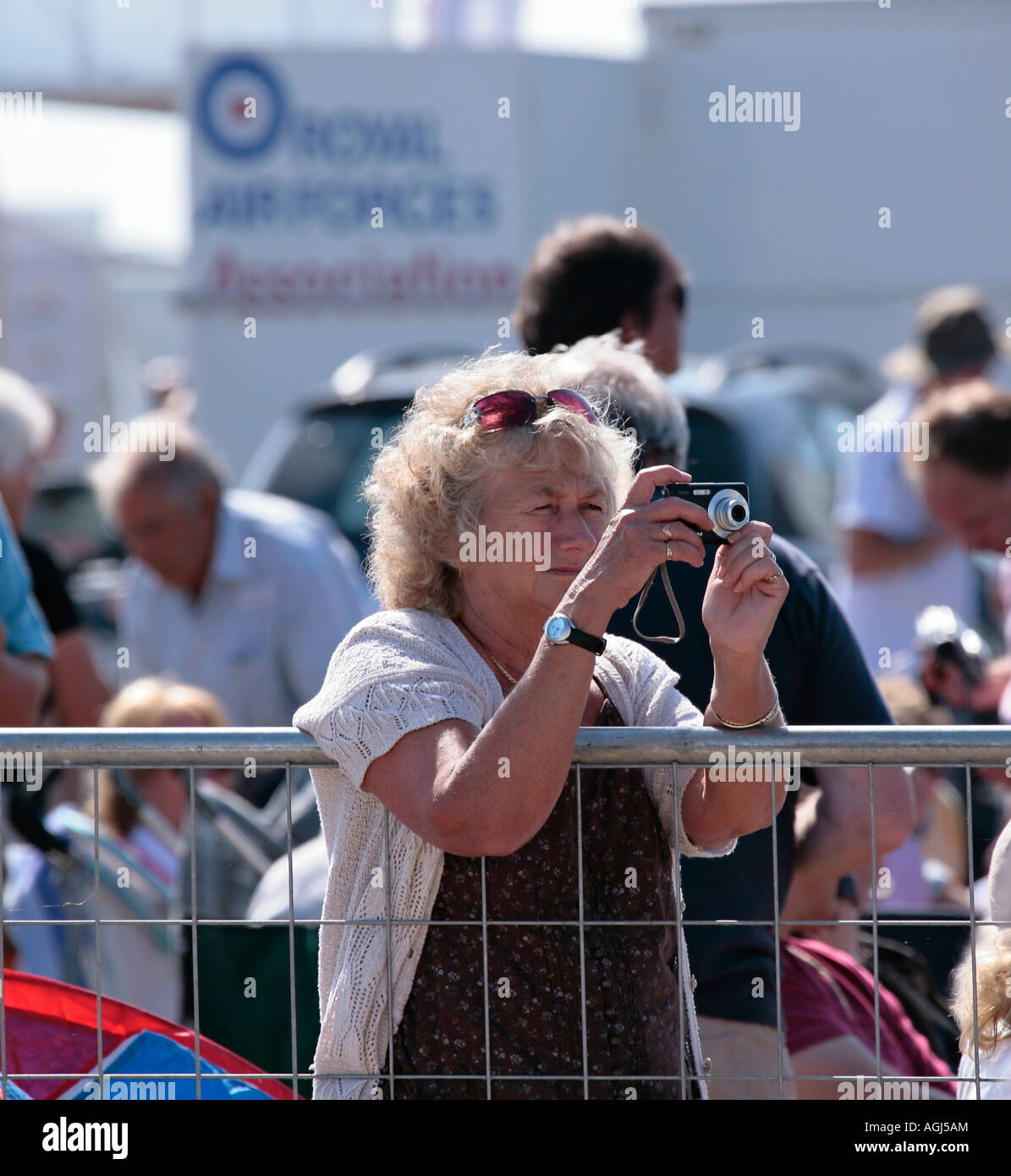 Adult female spectator taking pictures at Royal Air Forces Association ...