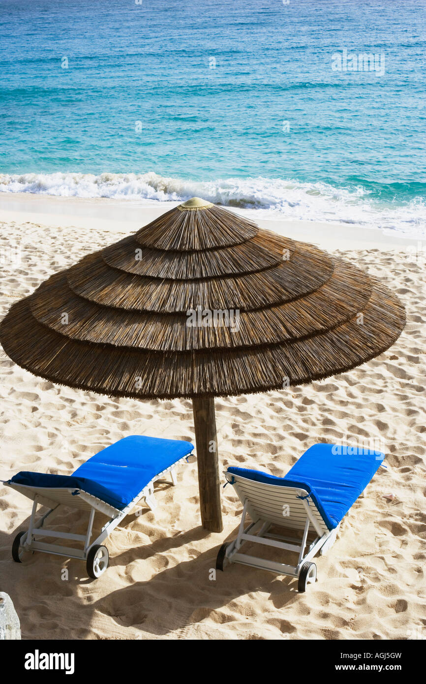 High angle view of two lounge chairs under a palapa on the beach Stock ...