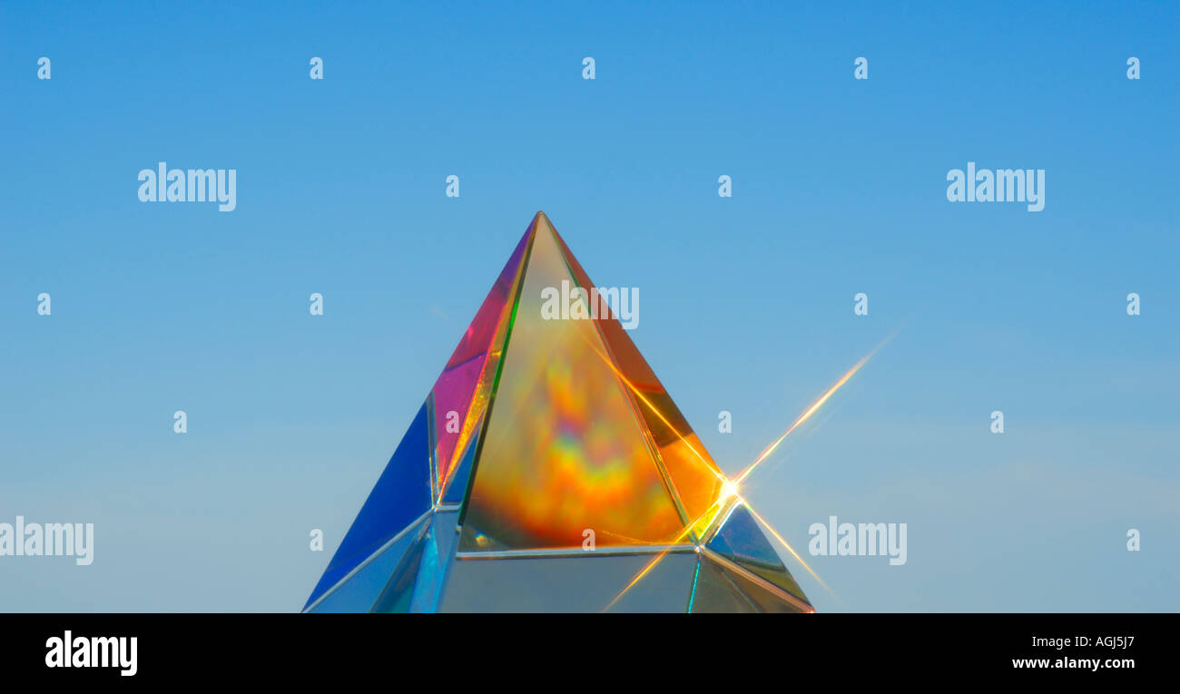 Glass pyramid with light rays reflected prism like Stock Photo - Alamy