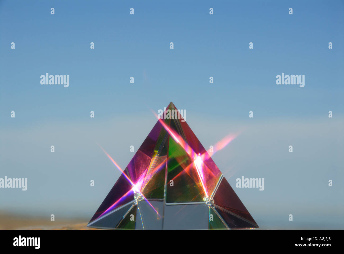Glass pyramid with light rays reflected prism like Stock Photo - Alamy
