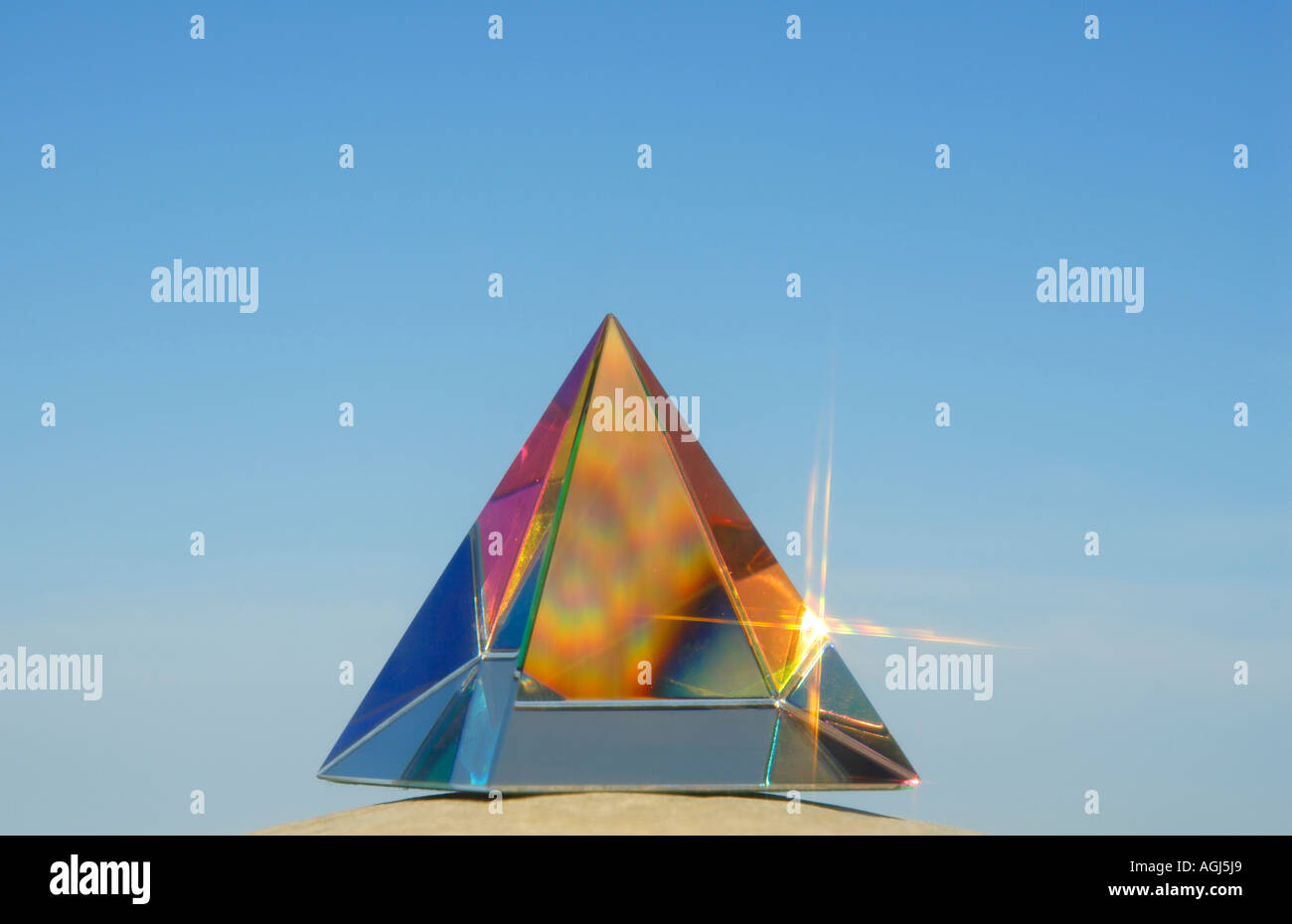 Glass pyramid with light rays reflected prism like Stock Photo - Alamy