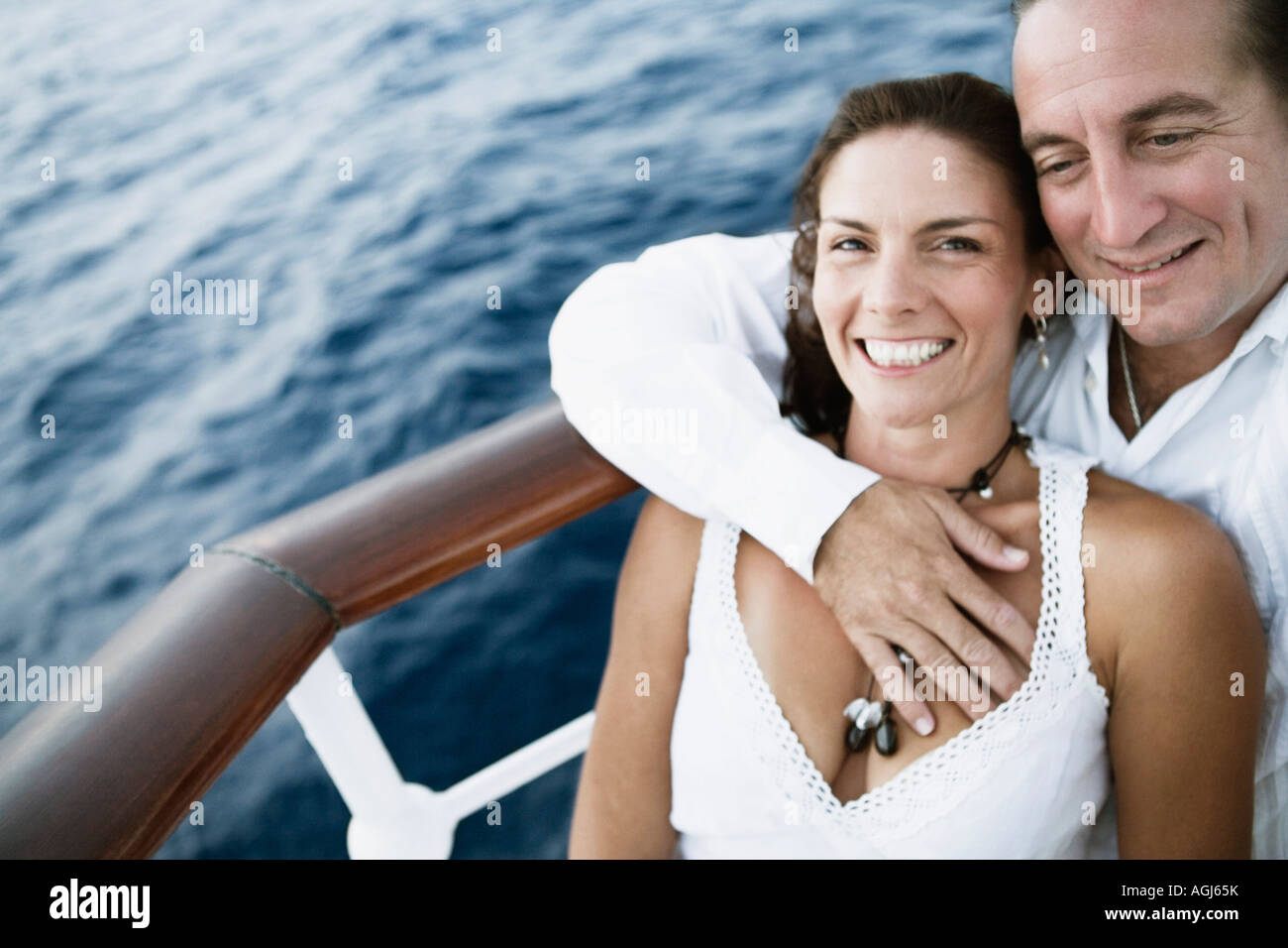 Close-up of a mid adult couple romancing in a ship Stock Photo - Alamy