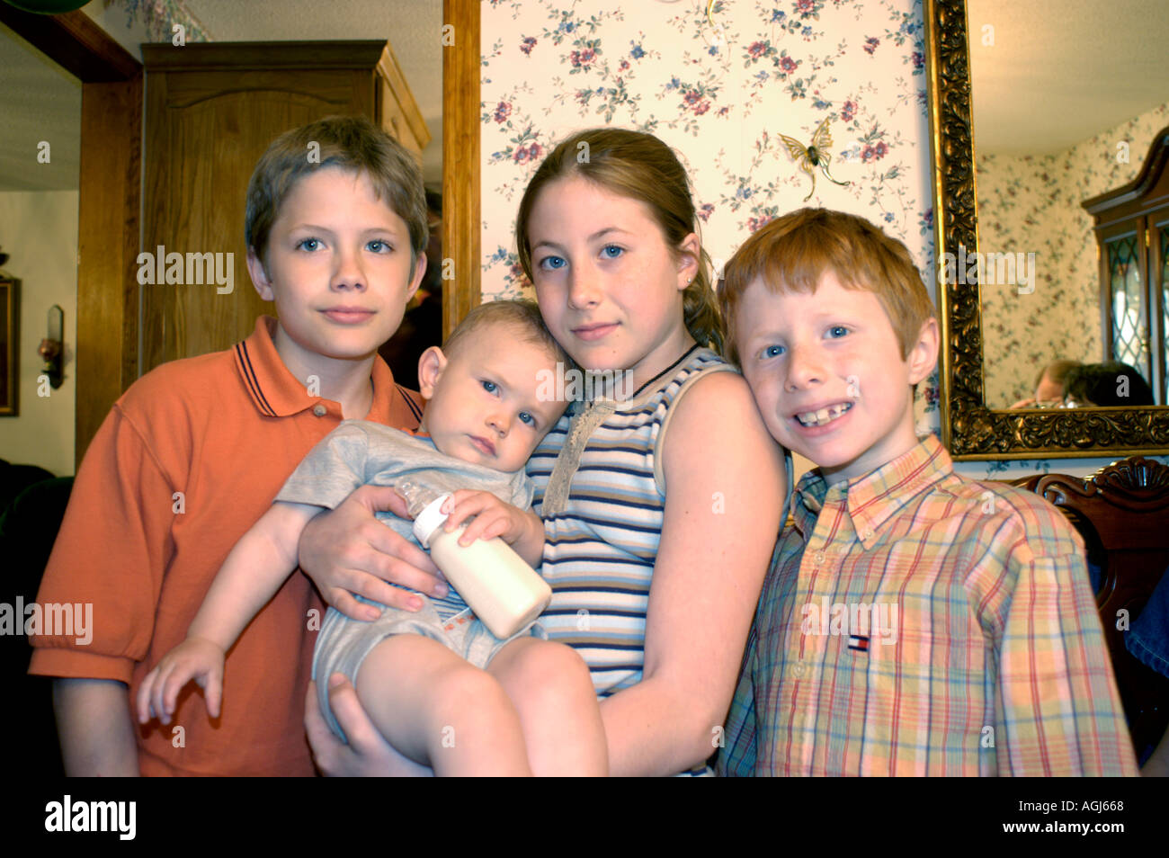 Three brothers and their older sister at home in group portrait Stock ...