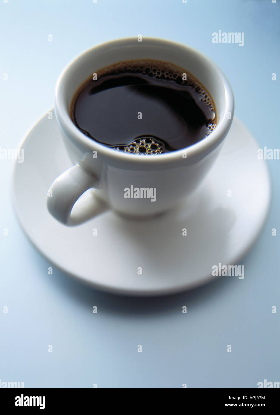 Black coffee in a small white cup and saucer Stock Photo - Alamy