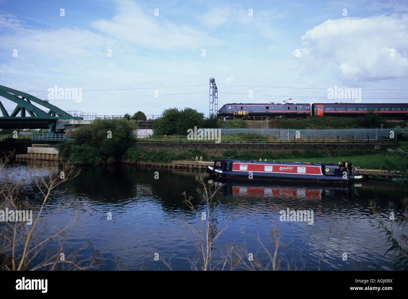 Canal barge pulling into moorings and passing electric train, River ...