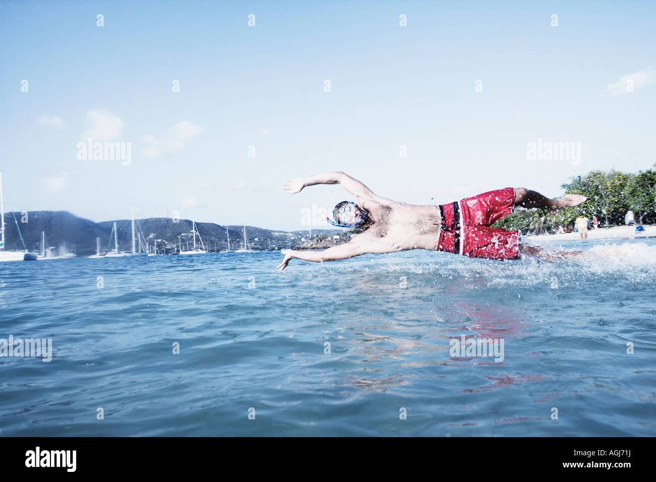 Mid adult man diving in water Stock Photo - Alamy