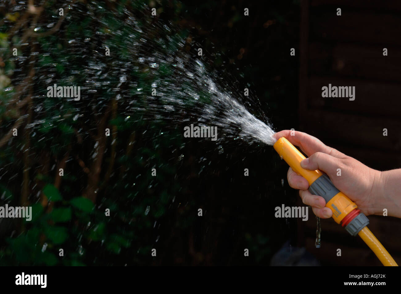Hand holding hosepipe hi-res stock photography and images - Alamy