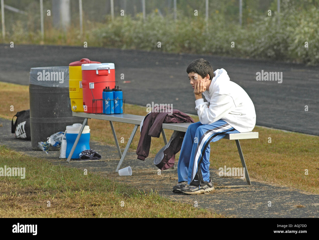 Injured american football player sitting on the bench in a sling ...
