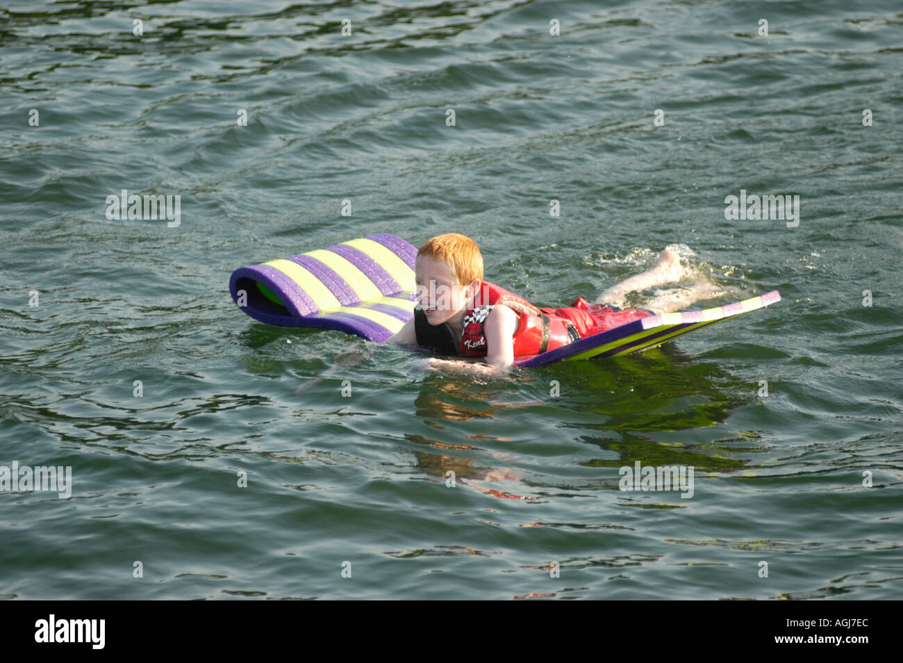 Kids playing on lake in inflatable rafts and tubs in the sun in Georgia ...