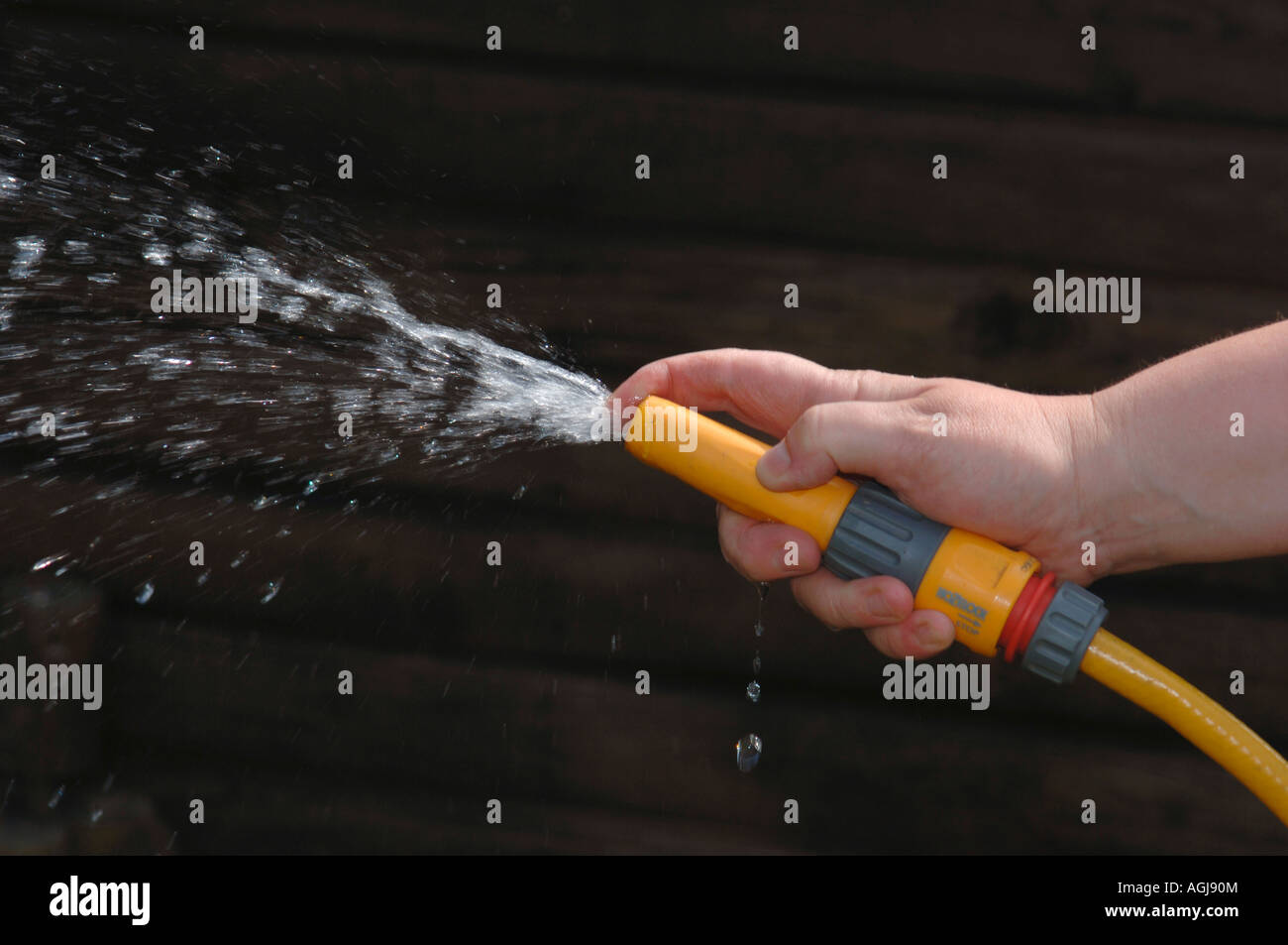 Hand holding hosepipe hi-res stock photography and images - Alamy