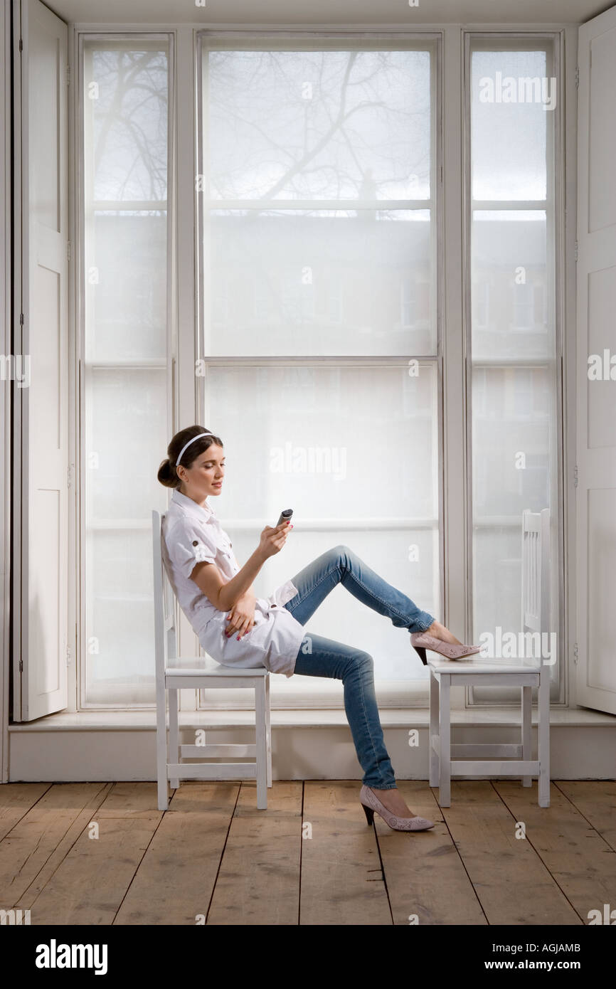 Woman one leg up on chair hi-res stock photography and images - Alamy