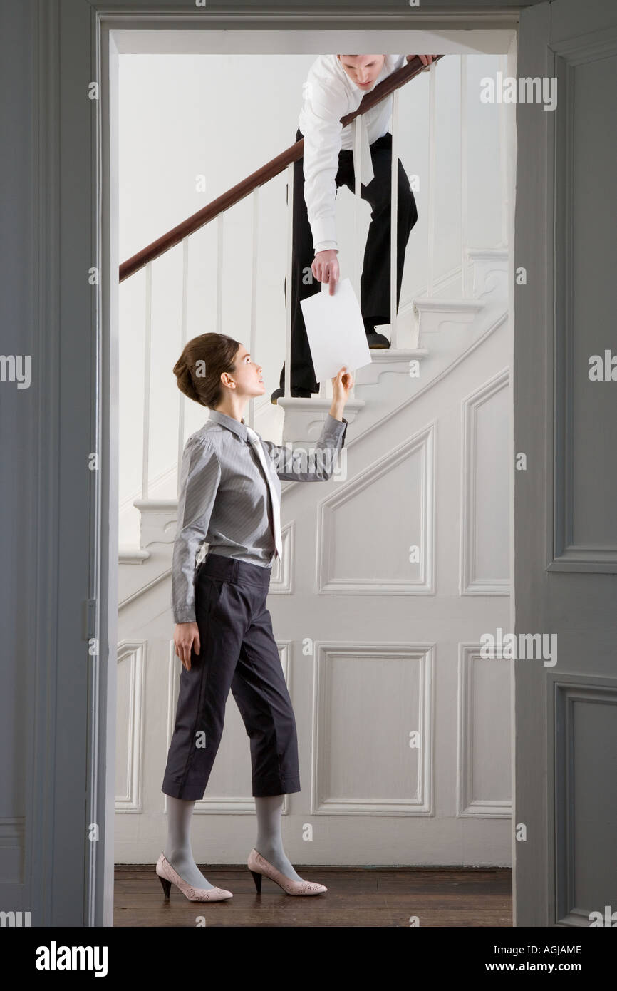 Woman passing paper to man Stock Photo - Alamy