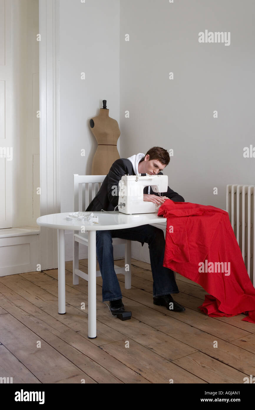 Man sewing red fabric Stock Photo - Alamy