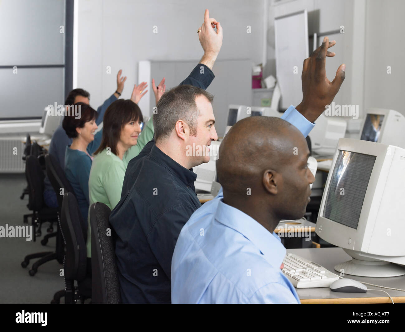 Sitting student hands raised chair hi-res stock photography and images ...