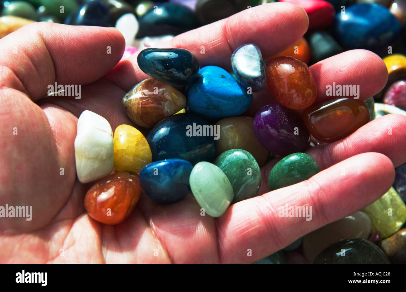 Hand holding colorful stones Stock Photo - Alamy