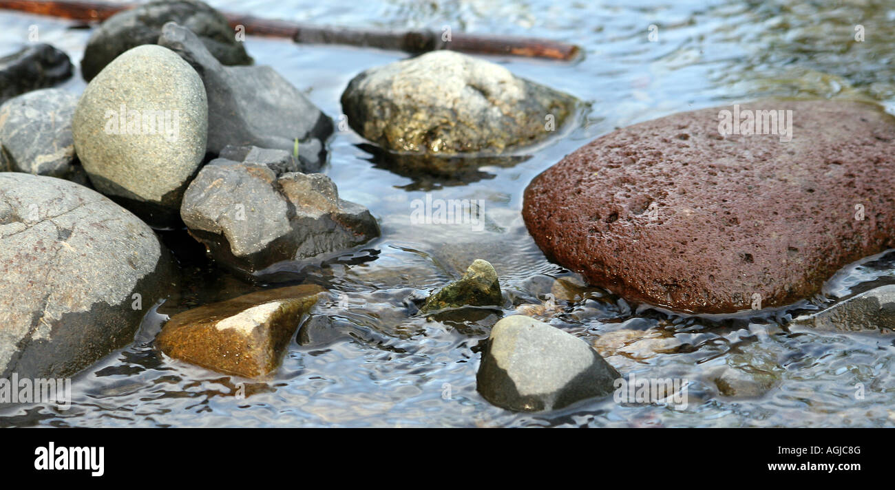 Water flows around rocks in a mountain creek Stock Photo - Alamy