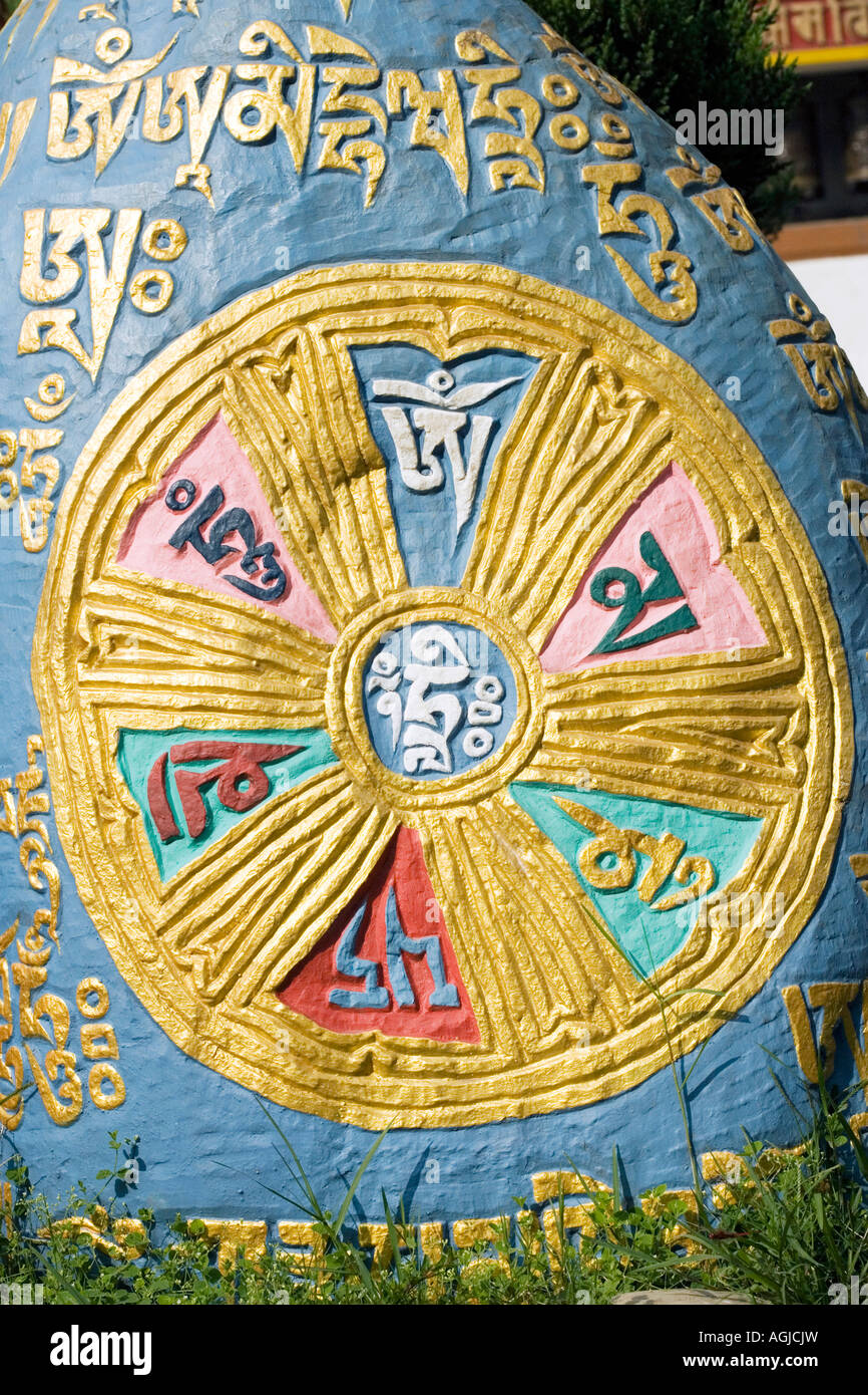 Stone painted with tibetan wheel and mantra text writing. Swayambhu ...