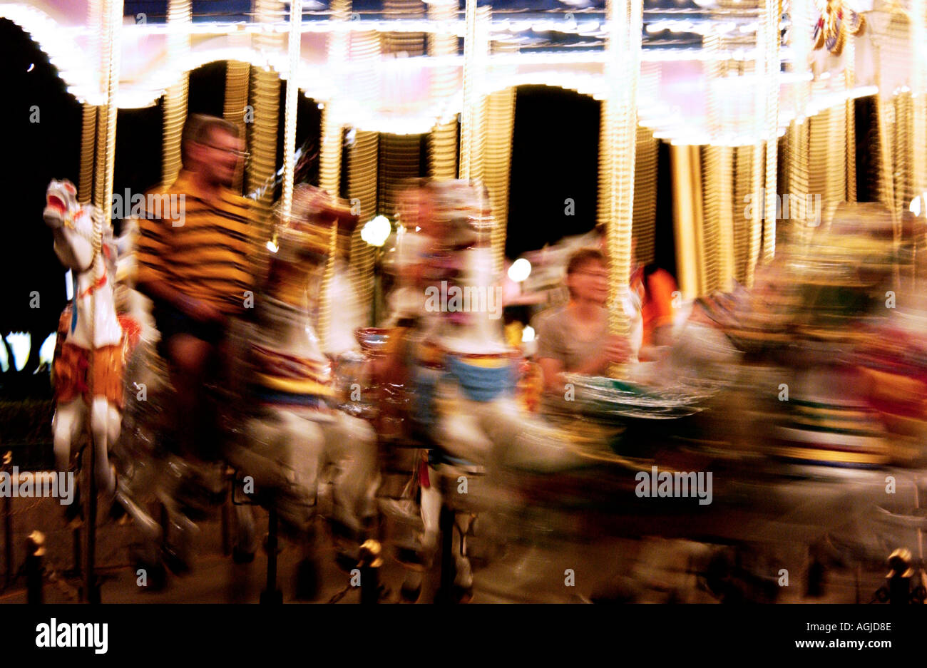 Family on merry go round Stock Photo - Alamy