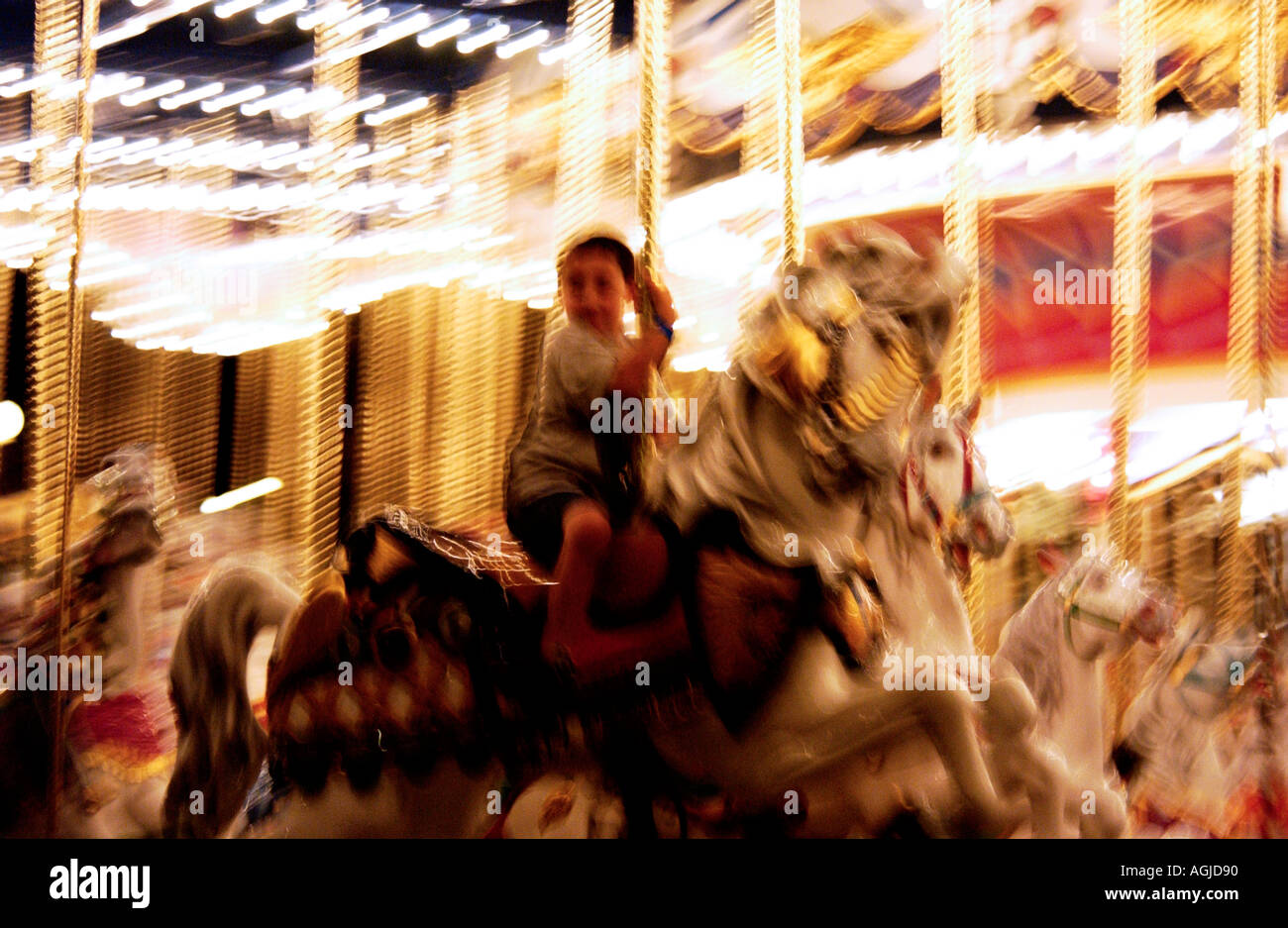 Kid on merry go round Stock Photo - Alamy