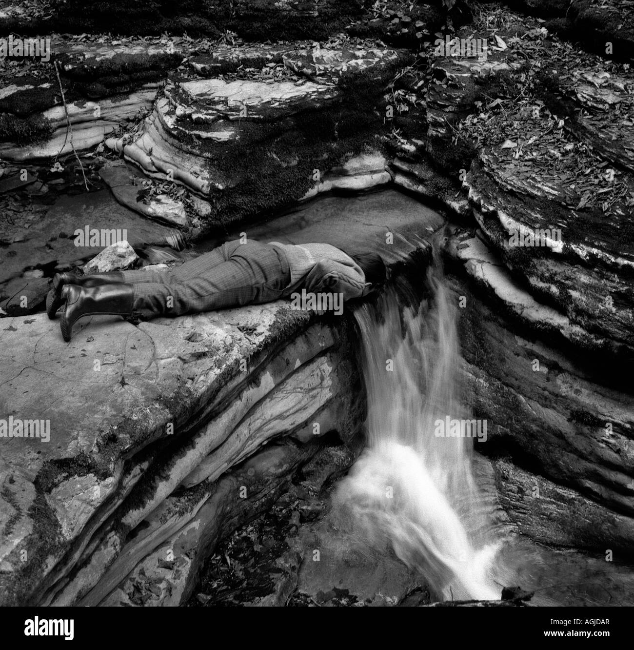 Young female drinking from a small mountain river waterfall Stock Photo ...