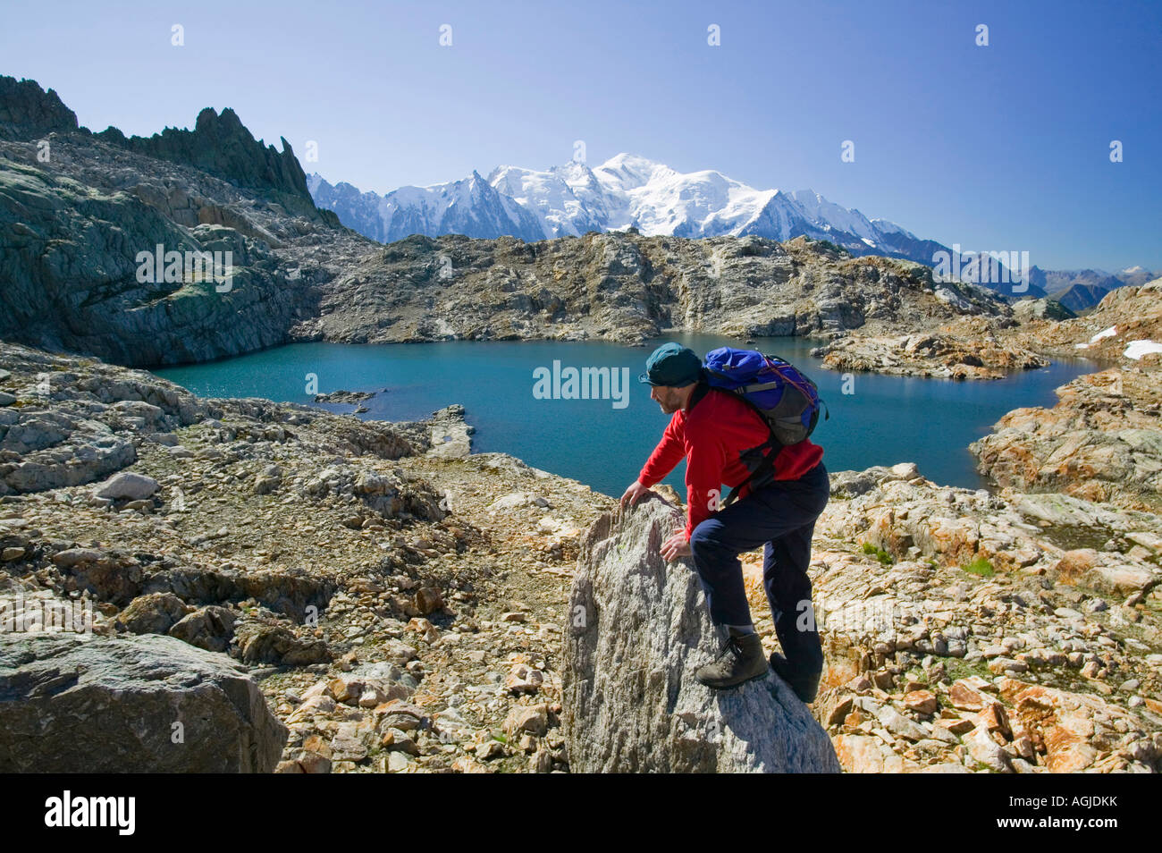 A climber at Lac Noir on the Aiguille Rouge mountains Chamonix France ...