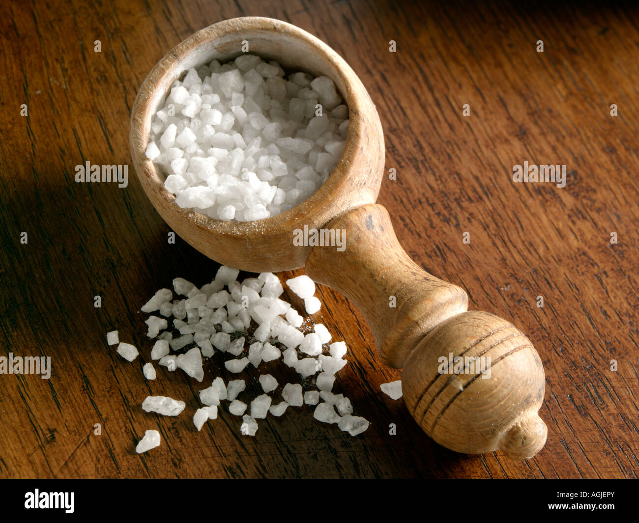 A scoop of sea salt on a wooden table close up Stock Photo - Alamy